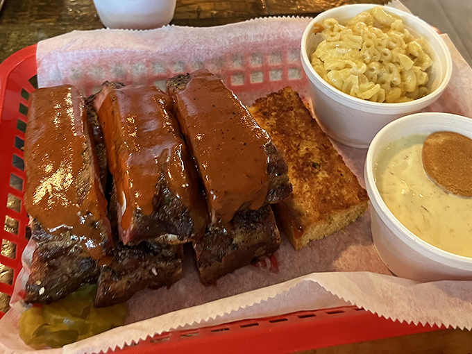 These ribs aren't just falling off the bone&mdash;they're practically jumping onto your fork. The cornbread isn't an afterthought; it's essential equipment for sauce-sopping duty. 