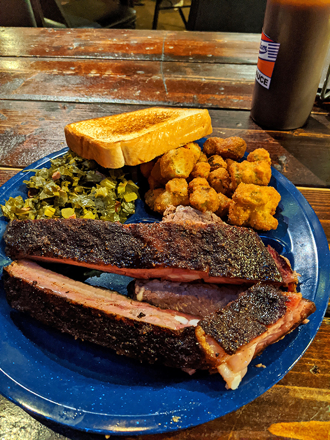Behold the star of the show: ribs with bark so perfect they should be in a museum, paired with collard greens that grandma would approve.