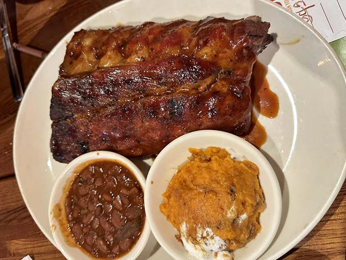 These ribs arrive glistening like edible mahogany, sided with beans and mac that deserve their own spotlight.