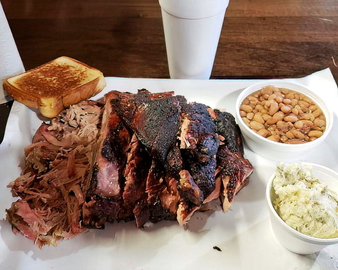 Behold the carnivore's dream team: fall-off-the-bone ribs with that perfect bark, pulled pork, and sides that refuse to be mere afterthoughts.