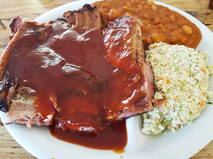 These ribs don't need a fancy introduction&mdash;they speak the universal language of perfectly smoked meat, tangy sauce, and sides that refuse to be upstaged.