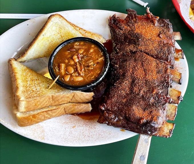 Dry-rubbed ribs that look like they've been kissed by smoke gods, served with Texas toast and beans that could make a Texan jealous.