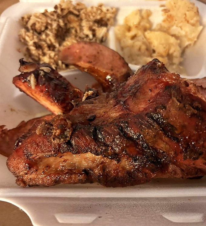 These ribs don't just fall off the bone—they practically leap into your mouth with a perfect bark that's earned through hours of patient smoking.