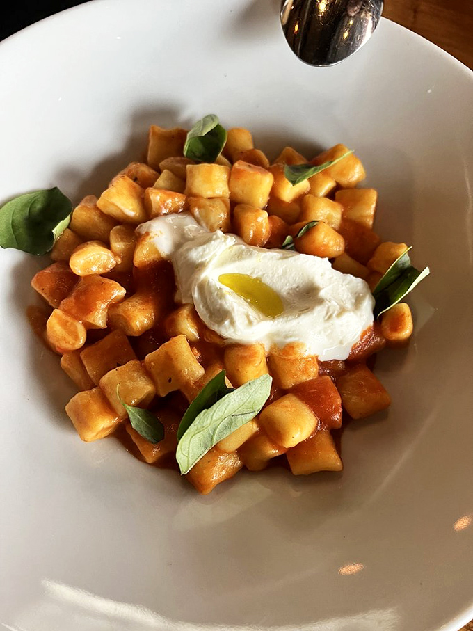 Cloud-like pillows of ricotta gnocchi swimming in tomato sauce. This isn't pasta; it's a religious experience with a side of basil.