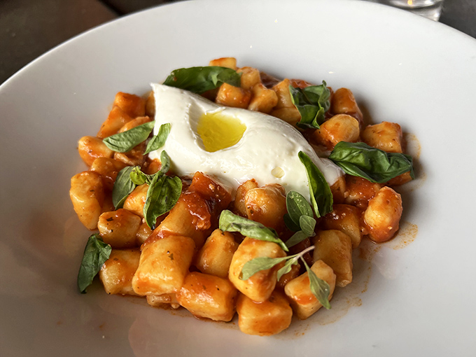 Cloud-like pillows of ricotta gnocchi swimming in tomato sugo with fresh basil&mdash;proof that heaven exists and it's made of cheese.