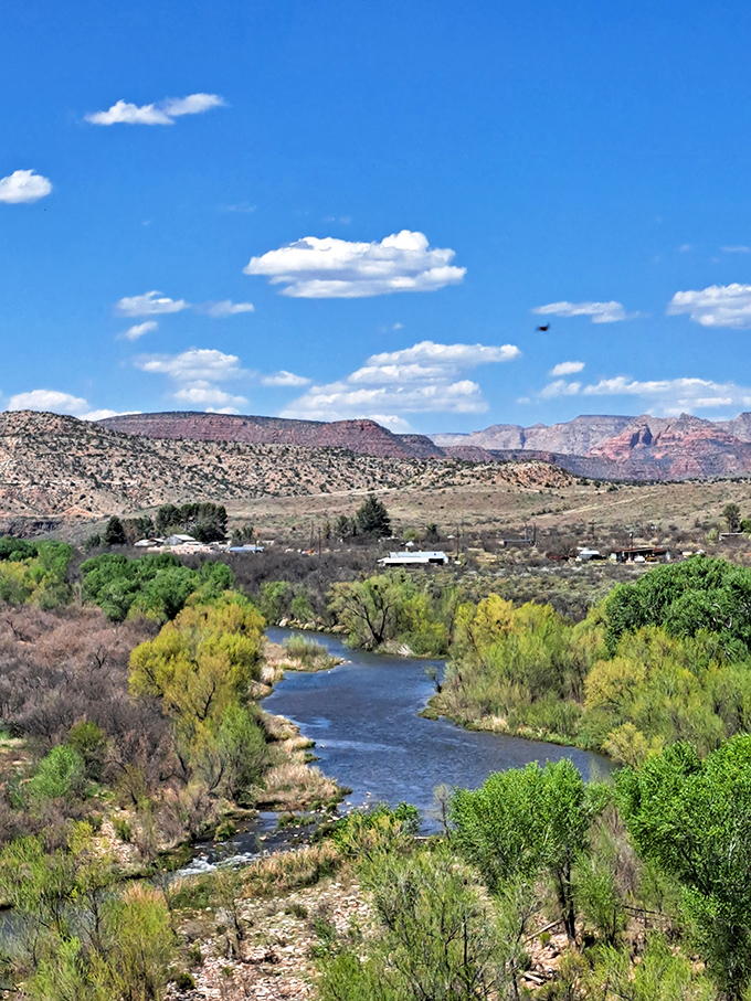 The Verde River carves its emerald path through the desert landscape, a life-giving artery in this otherwise rugged terrain.