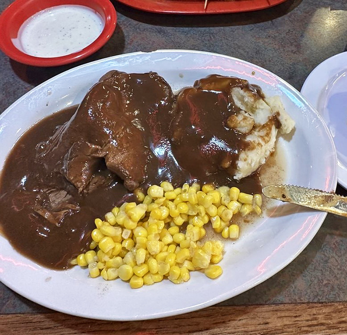 This isn't just roast beef &ndash; it's a brown gravy symphony with mashed potato backup singers and corn that's clearly happy to be part of the ensemble.