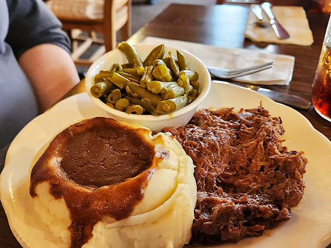 Behold the star attraction: roast beef so tender it practically surrenders to your fork, paired with mashed potatoes wearing a gravy hat.