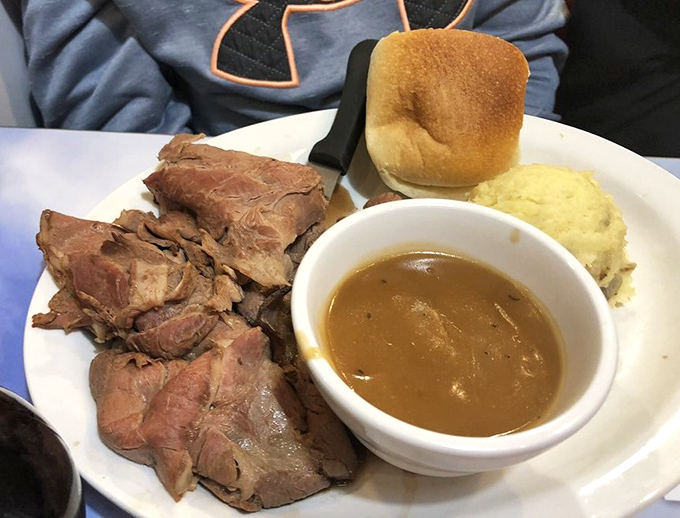 Behold the star of the show: tender slices of roast beef alongside golden mashed potatoes and gravy that would make your grandmother both proud and jealous.