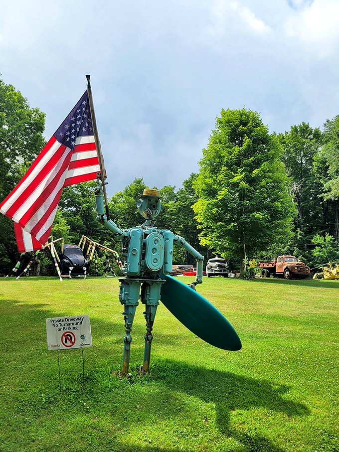 This teal robot sentinel proudly waves Old Glory, proving that even mechanical men can show their patriotic spirit in Erie's quirkiest attraction.