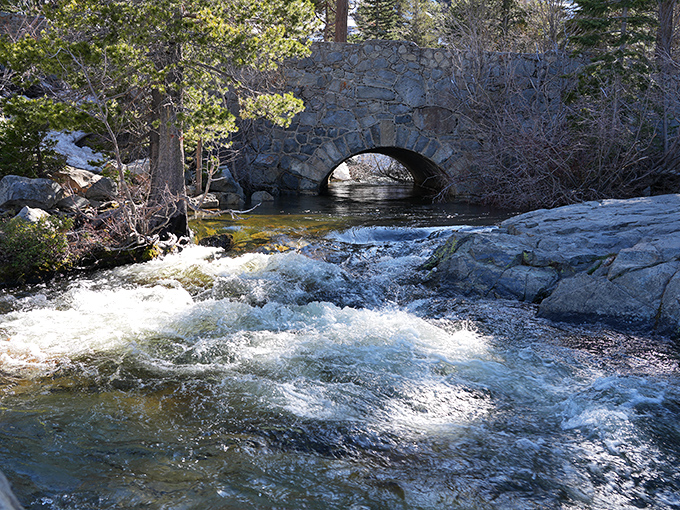 This isn't just any stone bridge&mdash;it's a portal to another world where rushing water has been sculpting masterpieces longer than Michelangelo.