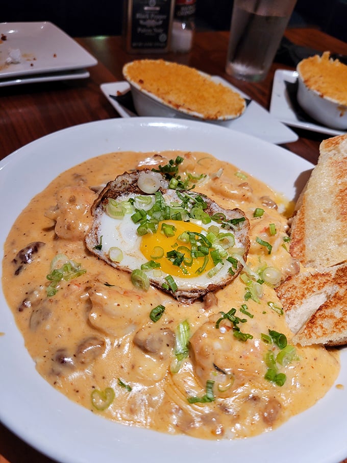 Shrimp and grits that would make a Charleston chef weep with joy. That sunny-side egg is the breakfast hat this dinner dish deserves.