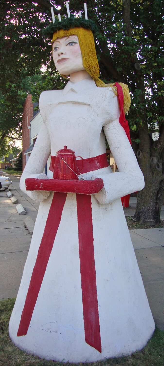 Saint Lucia stands sentinel in her traditional white gown, coffee pot in hand &ndash; because even Swedish traditions understand caffeine is non-negotiable.