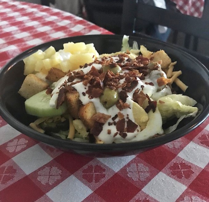 Not just a steakhouse afterthought. This loaded salad with bacon bits and house dressing proves vegetables can hold their own against the main attraction.
