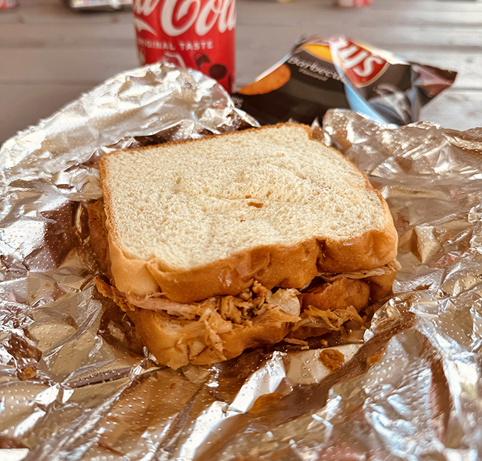 Behold barbecue in its purest form &ndash; tender smoked pork nestled between slices of white bread, a sandwich so honest it makes fast food weep with shame.