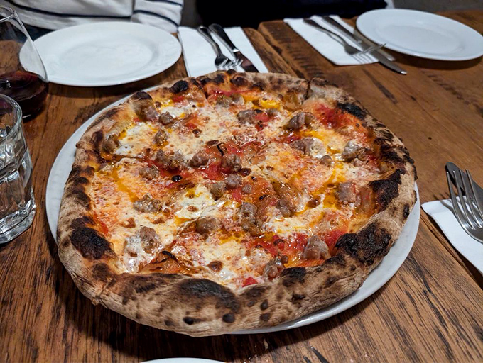 The Santo pizza arrives like edible artwork &ndash; that perfectly charred crust supporting a harmonious blend of sausage and cheese that makes time stand still.