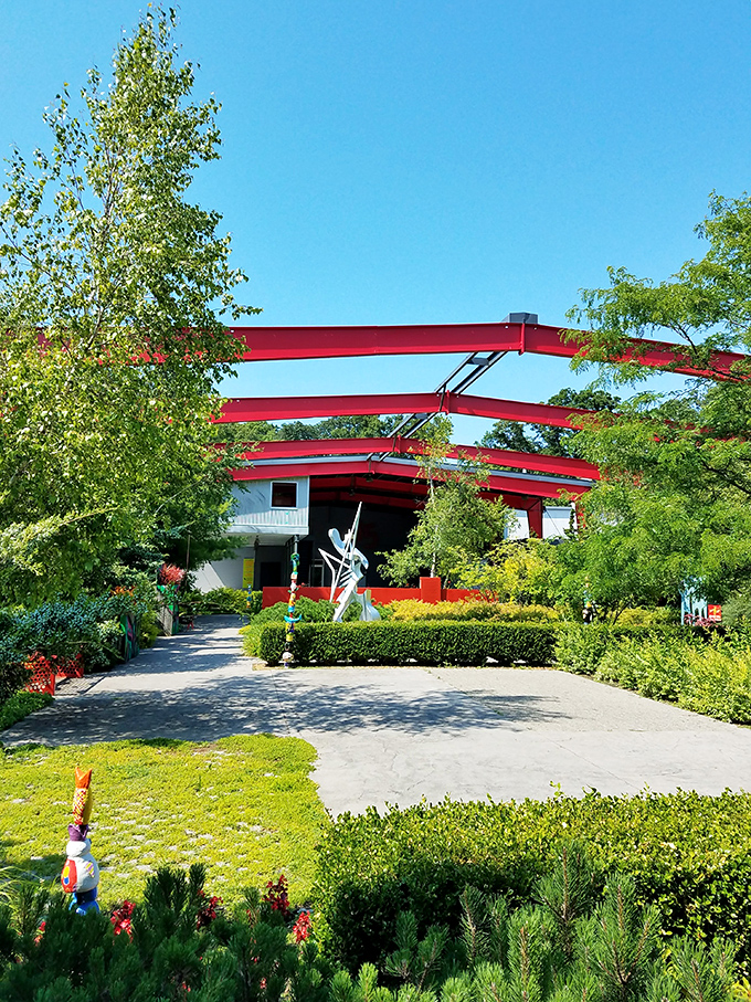 Bold red beams reach skyward at the Saugatuck Center for the Arts, where culture blooms as vibrantly as the surrounding gardens.