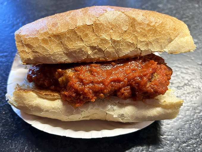 Behold the majesty of properly grilled meat nestled in fresh bread - simplicity perfected through careful craftsmanship.