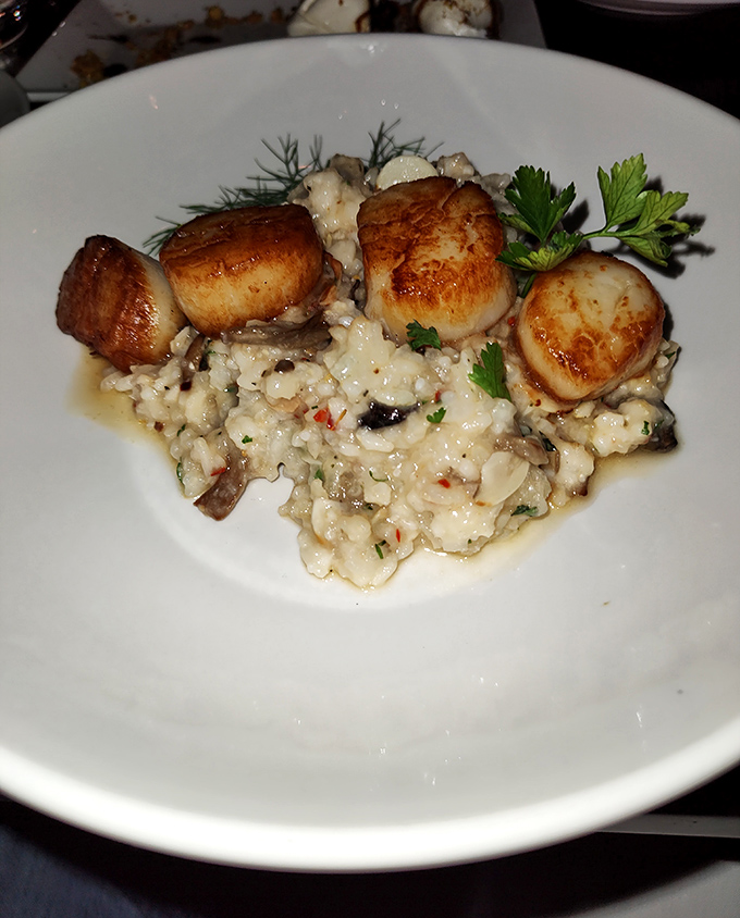 These scallops aren't just cooked, they're transformed. Golden-seared perfection atop creamy risotto&mdash;the kind of dish that ruins all other scallops for you forever.