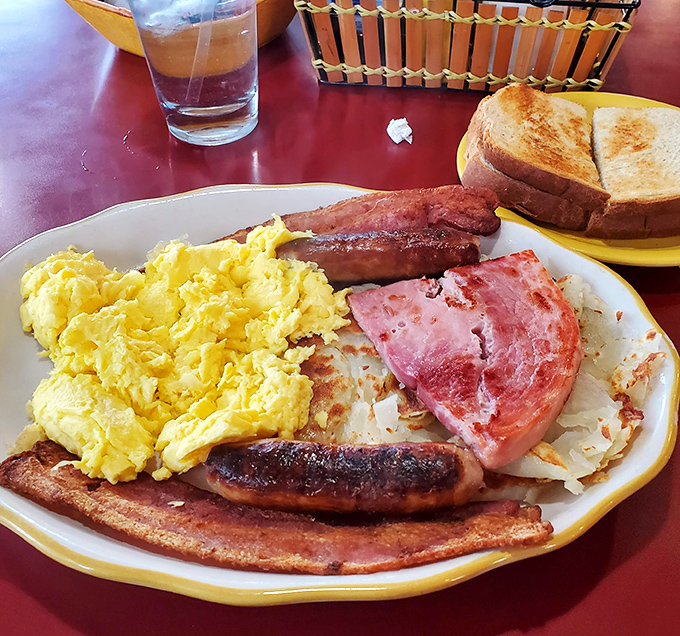 Breakfast perfection on a plate: fluffy scrambled eggs alongside crispy bacon and ham&mdash;the holy trinity of morning satisfaction.