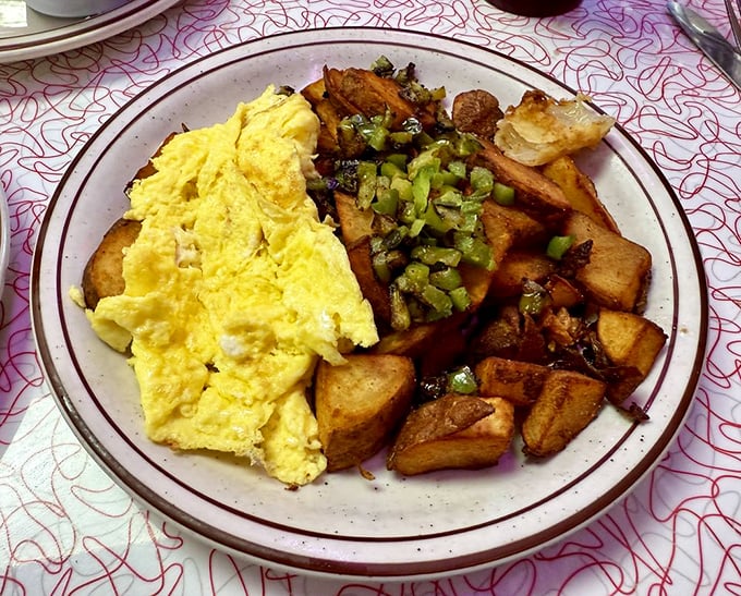 Sunshine-yellow scrambled eggs nestle against golden home fries with green peppers&mdash;a plate that says "good morning" better than words ever could.