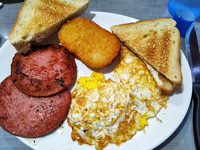 Breakfast perfection on a plate &ndash; golden eggs, crispy scrapple, and toast that's achieved that magical butter-to-crunch ratio that haunts your dreams.