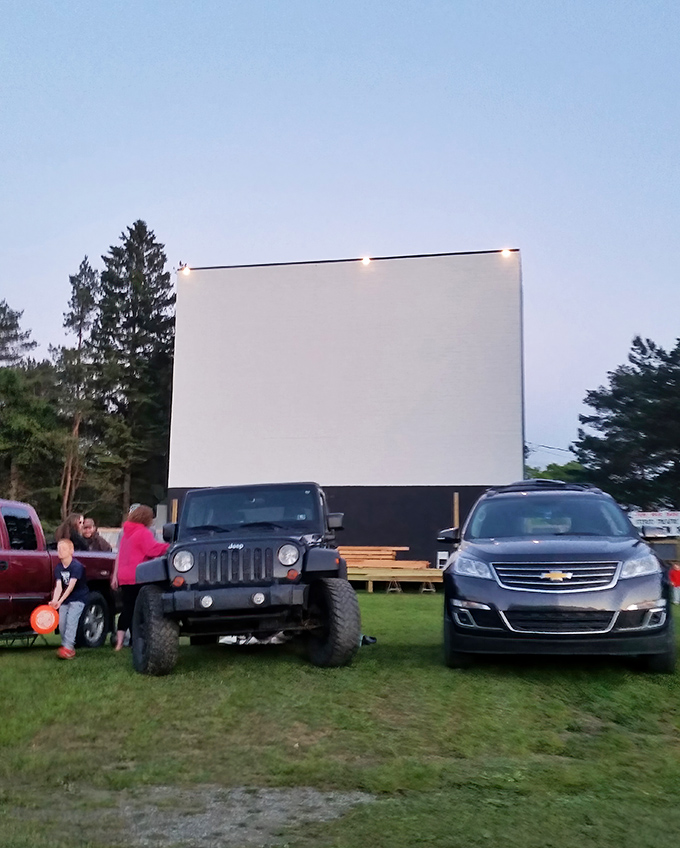 Jeeps and sedans alike find common ground at twilight, their headlights dimmed in anticipation of Hollywood magic.