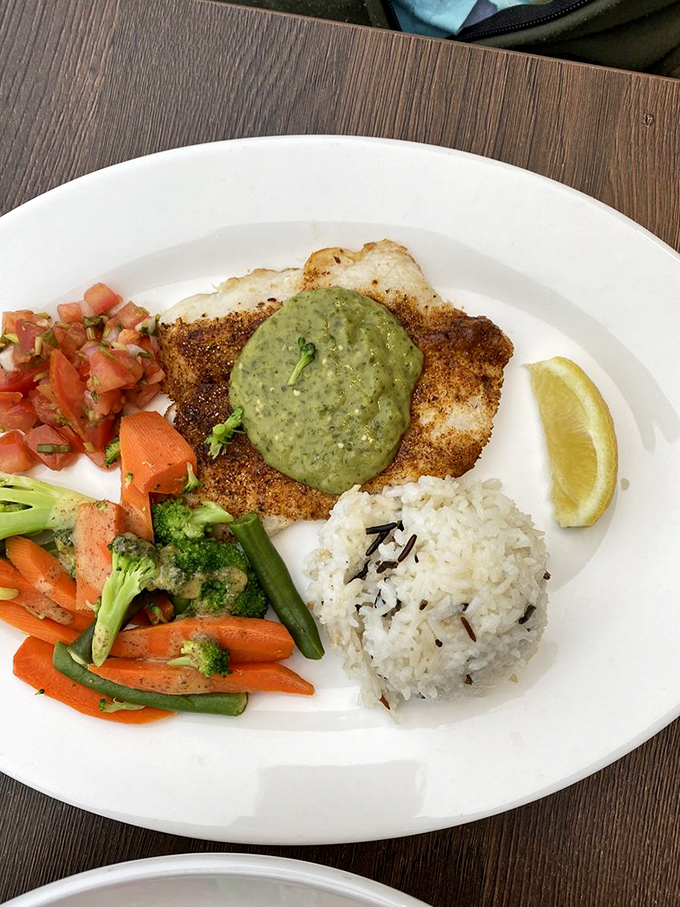 This isn't just fish &ndash; it's an experience. Perfectly seasoned, expertly cooked, and presented with colorful vegetables and rice that aren't mere afterthoughts.