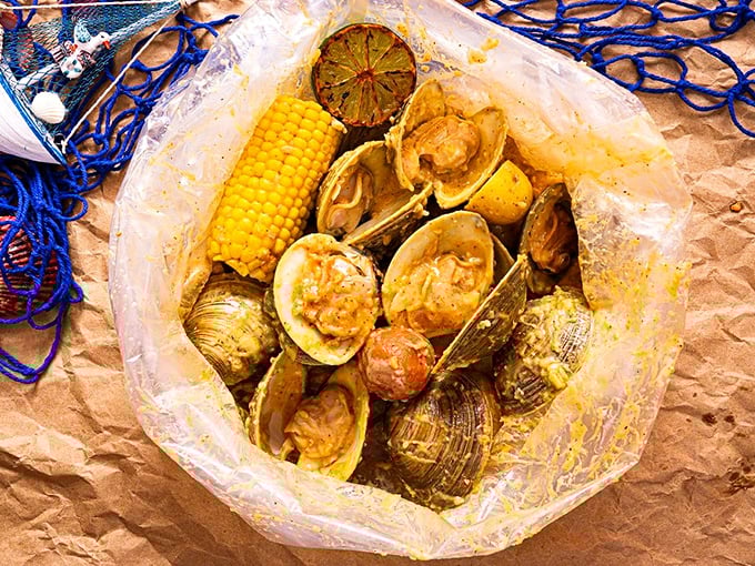 Seafood boils arrive like edible presents&mdash;clear bags bursting with clams, corn, and potatoes swimming in sauce that's worth every napkin you'll need.