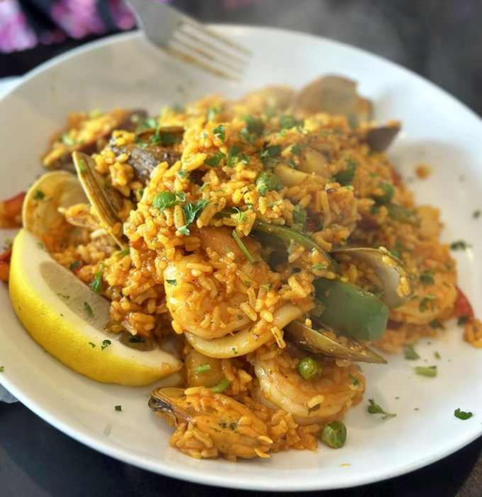 This paella looks like sunset at the beach decided to take up residence on a plate.