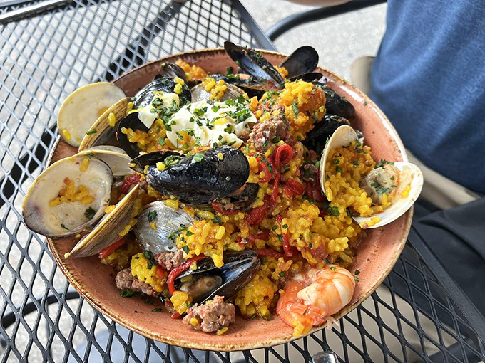 Paella that would make Valencia jealous. This colorful Spanish-inspired masterpiece showcases mussels, clams, and saffron rice in perfect harmony.