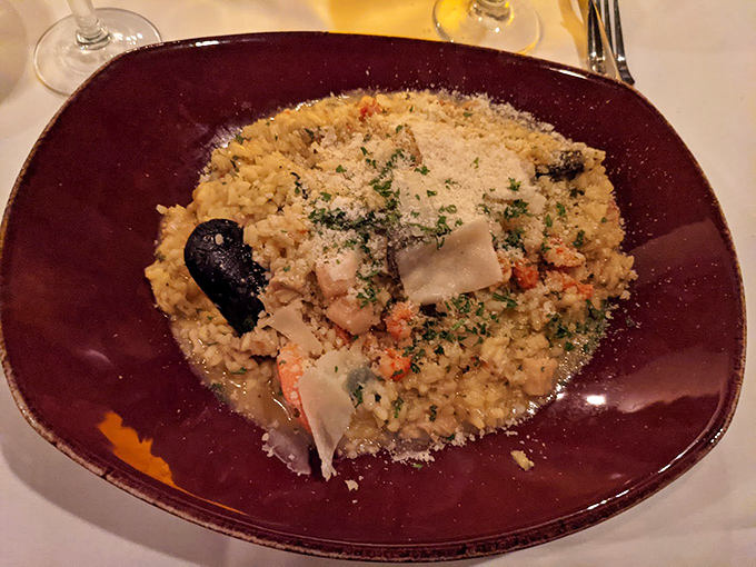The legendary seafood risotto arrives like edible artwork&mdash;creamy rice cradling treasures from the sea, finished with a snowfall of Parmesan. Worth every calorie.