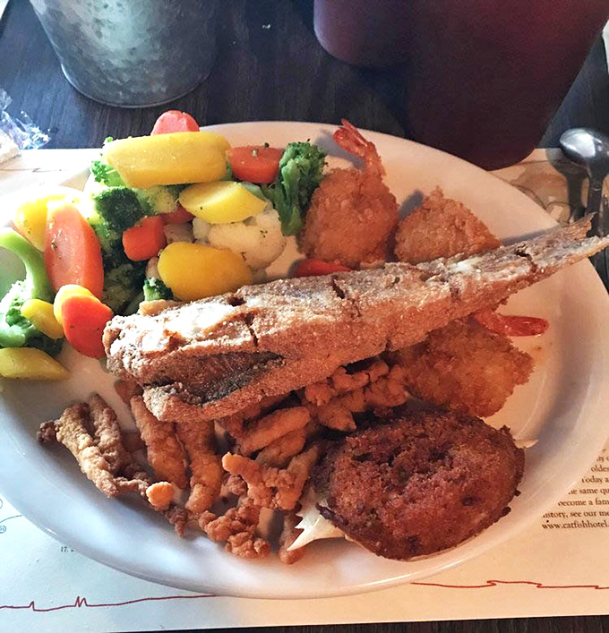 This isn't just dinner; it's a Tennessee masterpiece. Golden-fried catfish, farm-fresh vegetables, and hushpuppies that could make a food critic weep with joy.