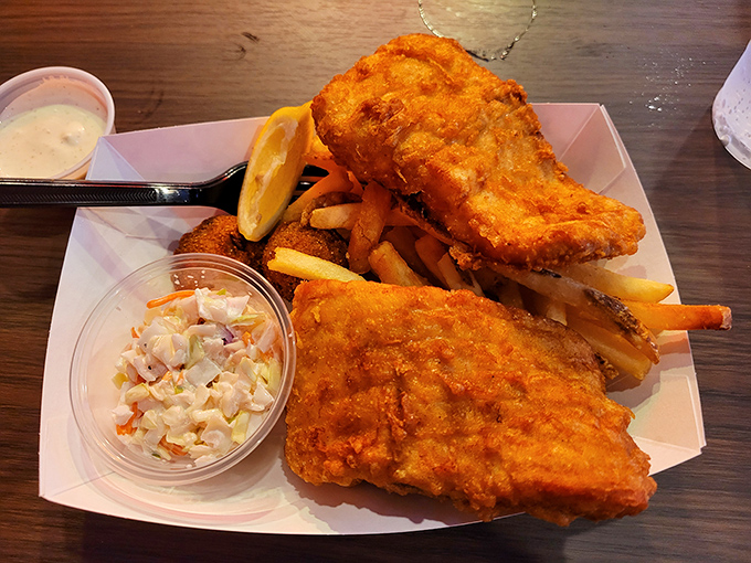 Golden-battered whitefish fillets that shatter with each bite, revealing pearly flesh beneath. This is what happens when fresh catches meet culinary respect.