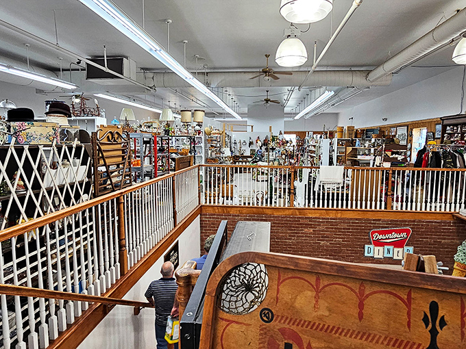 The second floor overlook reveals the true scale of this treasure trove, where shoppers below navigate a sea of history while that Downtown Diner sign winks knowingly.
