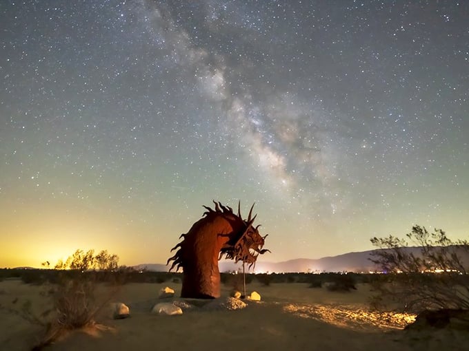 When night falls over Borrego Springs, the dragon sculpture transforms into a mythical sentinel beneath the Milky Way's celestial river.