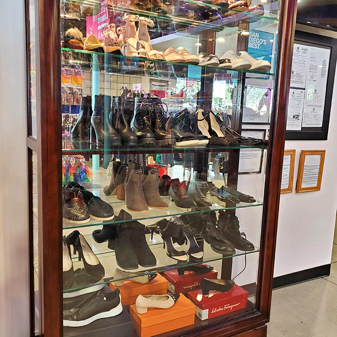 A glass case of footwear possibilities&mdash;where someone's barely-worn designer boots await their second chance at sidewalk stardom.