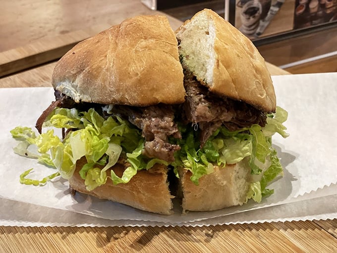 Behold the short rib sandwich that launched a thousand road trips! Tender meat, fresh greens, and a bun that deserves its own fan club create harmony in handheld form.