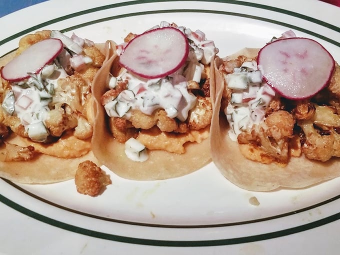 These shrimp tacos aren't just topped with radish slices&mdash;they're wearing little pink berets like culinary artists ready to paint masterpieces on your taste buds.