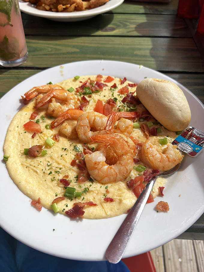 These aren't just shrimp and grits; they're a Southern love letter written in creamy cornmeal and punctuated with plump Gulf shrimp and bacon exclamation points.