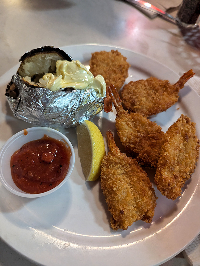 Golden-fried shrimp arrives with that baked potato treasure chest, because surf and turf never goes wrong.
