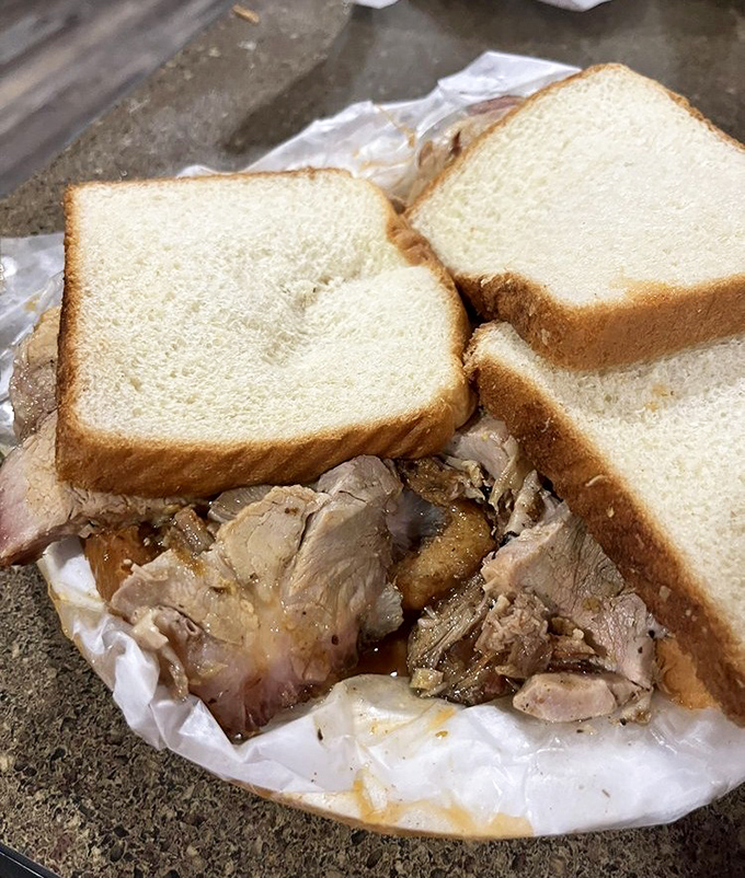 Actual slices of pork nestled between white bread&mdash;this is barbecue that respects both tradition and your taste buds.
