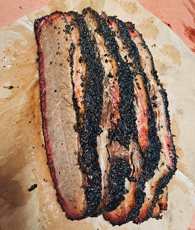 Brisket slices that could make a Texan weep with joy. That bark, that smoke ring, that tenderness&mdash;it's the holy trinity of barbecue perfection.