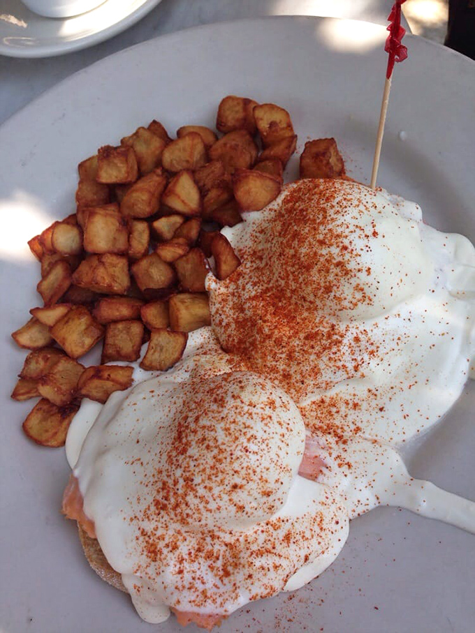 Behold the legendary Smoked Salmon Benedict! Those perfectly poached eggs with paprika-dusted hollandaise are Miami's answer to breakfast royalty.