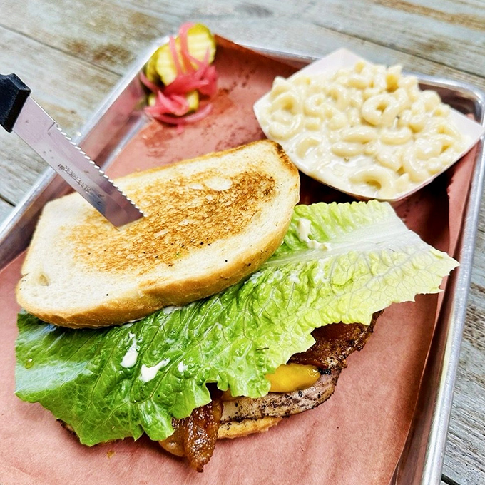 The legendary smoked turkey club arrives like a delicious architectural achievement&mdash;layers of house-smoked turkey, crisp lettuce, and toasted bread with mac and cheese standing guard.