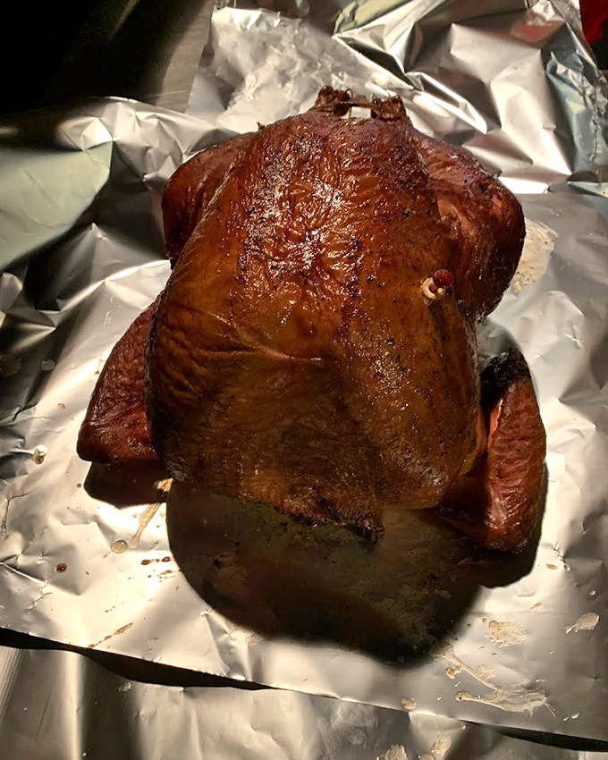 Behold the star attraction: smoked turkey with a mahogany sheen that would make fine furniture jealous. This bird didn't just fly&mdash;it soared through flavor country.
