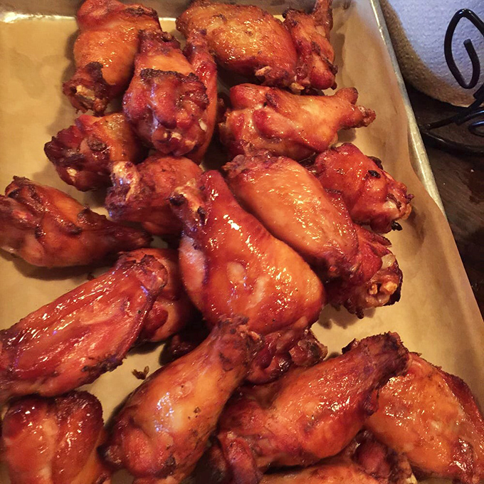 These wings aren't just smoked, they're transformed—glistening with a perfect lacquer that signals flavor depths worth crossing state lines for.