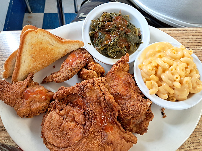Golden-brown perfection on a plate! This fried chicken with turnip greens and mac & cheese is the holy trinity of Southern comfort food.
