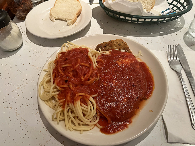 Behold, the holy trinity of Italian-American dining: perfectly cooked spaghetti, vibrant red sauce, and a cutlet that deserves its own fan club. Simplicity that sings.