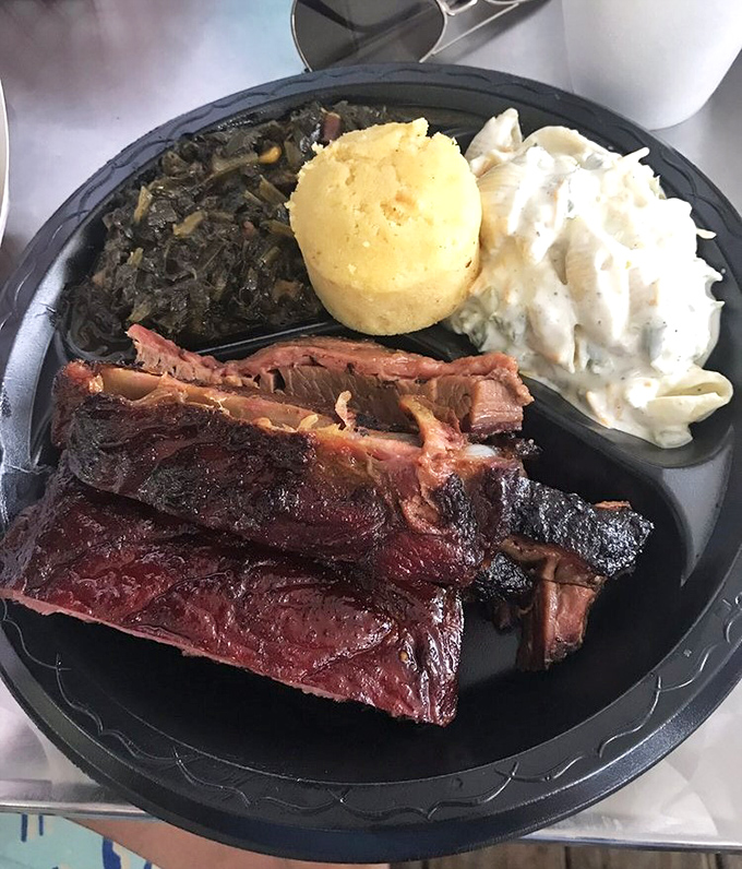 Behold, the St. Louis ribs in their smoky glory! With collards, cornbread, and coleslaw standing by, this plate is the barbecue equivalent of hitting the lottery.